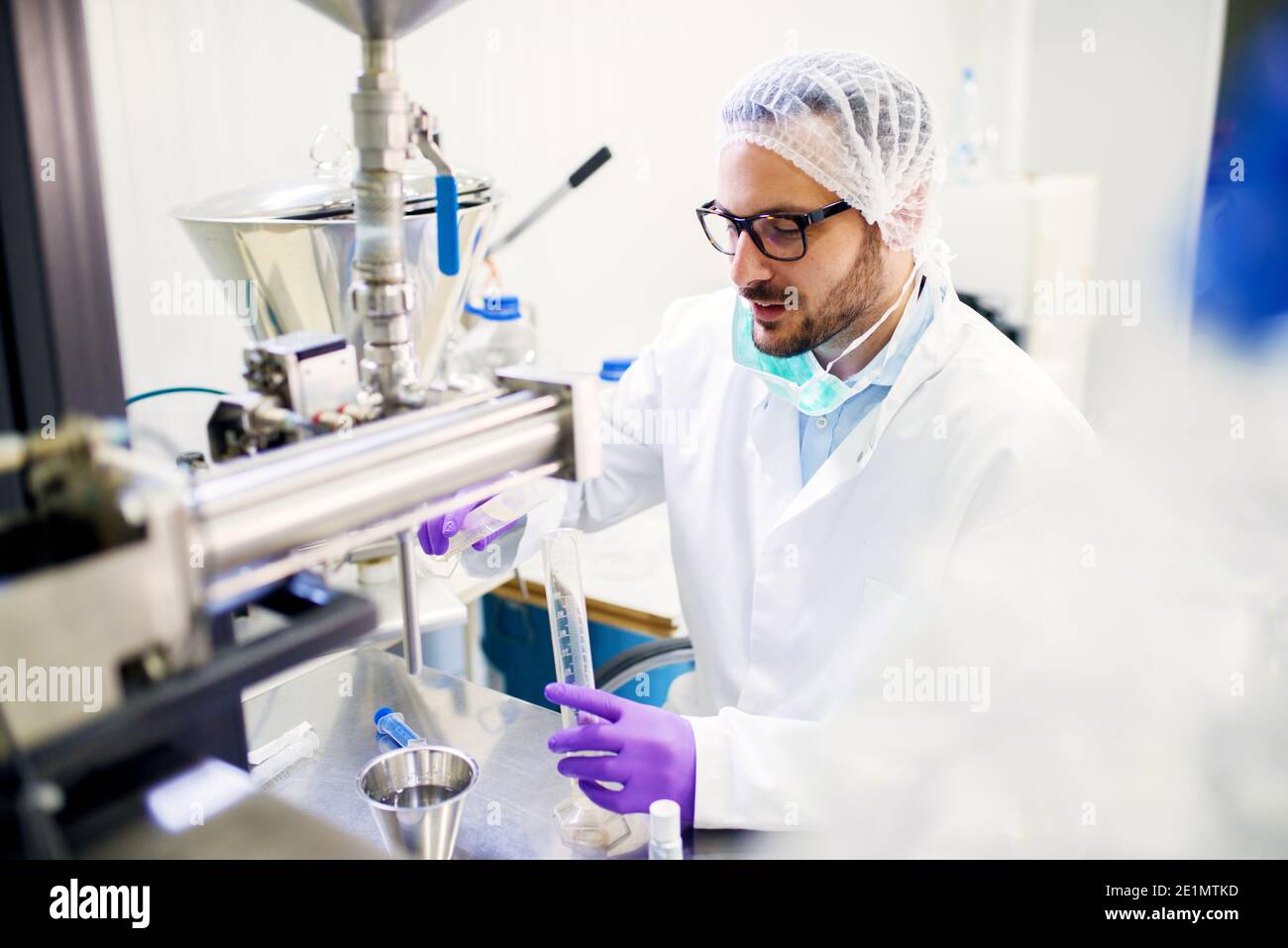 Young hard working man in protective wear working in laboratory Stock ...