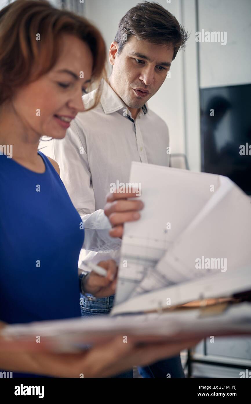 Two colleagues preparing paperwork for a meeting together Stock Photo ...