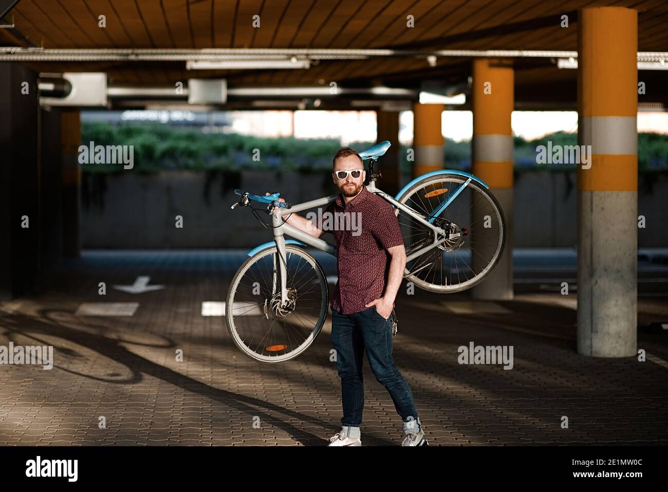 A handsome redhead male holding blue bicycle Stock Photo - Alamy