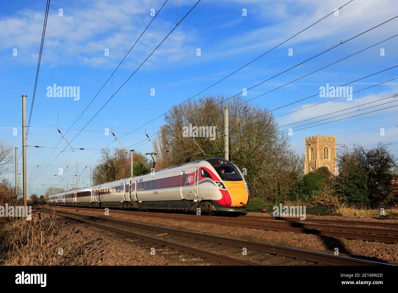 LNER, Azuma 800 class train passing Offord Cluny village, East Coast Main Line Railway ...