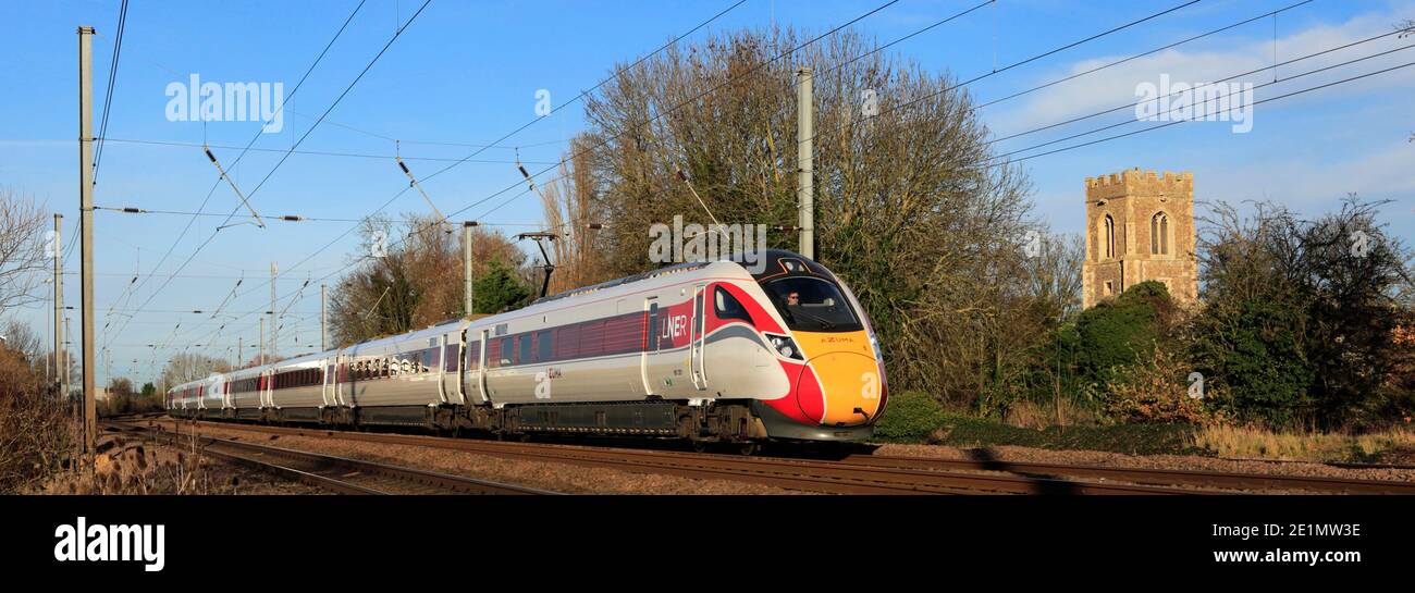 LNER, Azuma 800 class train passing Offord Cluny village, East Coast Main Line Railway ...