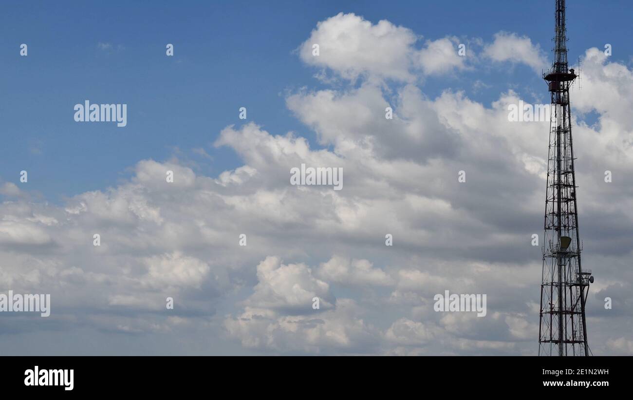 Cloudscape with industrial communication tower antennas transmitting data, repeaters for mobile ...