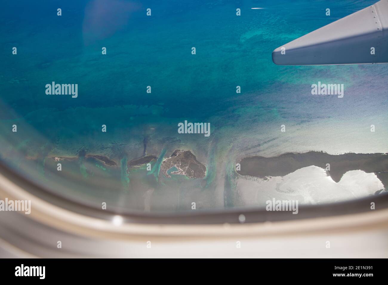 Plane window view with blue sky and sea Stock Photo - Alamy