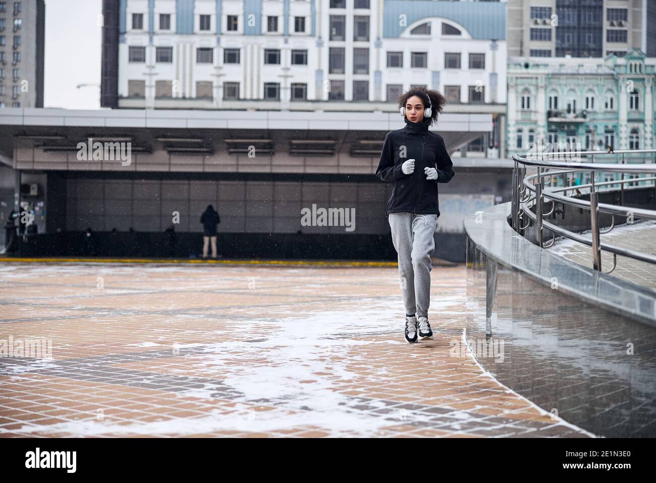 Athlete is jogging along the pathway fence Stock Photo - Alamy