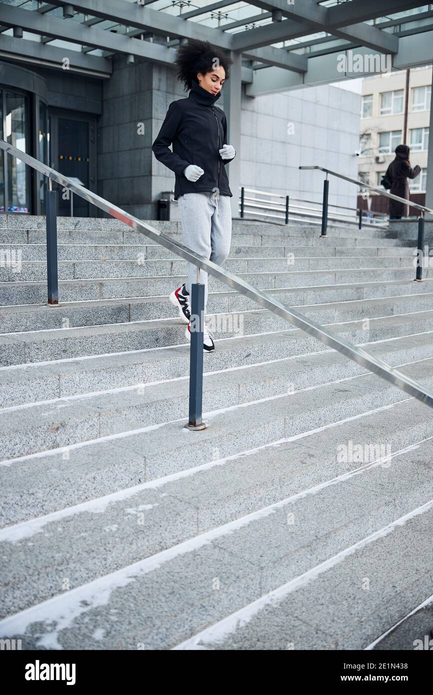 Person coming down the stairs hi-res stock photography and images - Alamy