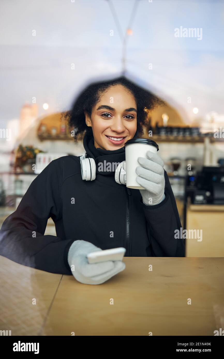 Customer in a cafe taking a sip of coffee Stock Photo - Alamy