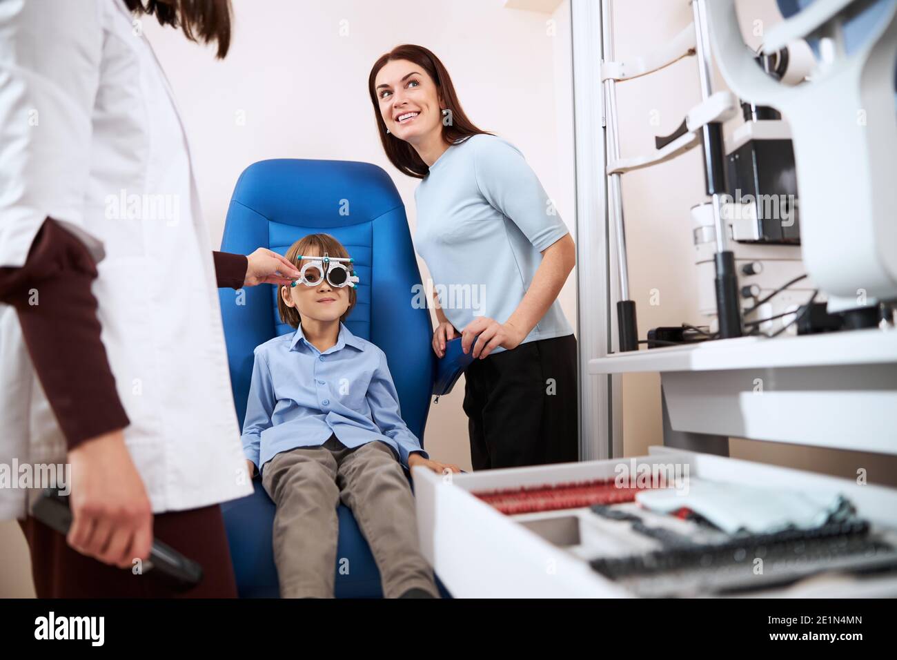 Unsure child trying to see letters on an eye chart Stock Photo - Alamy