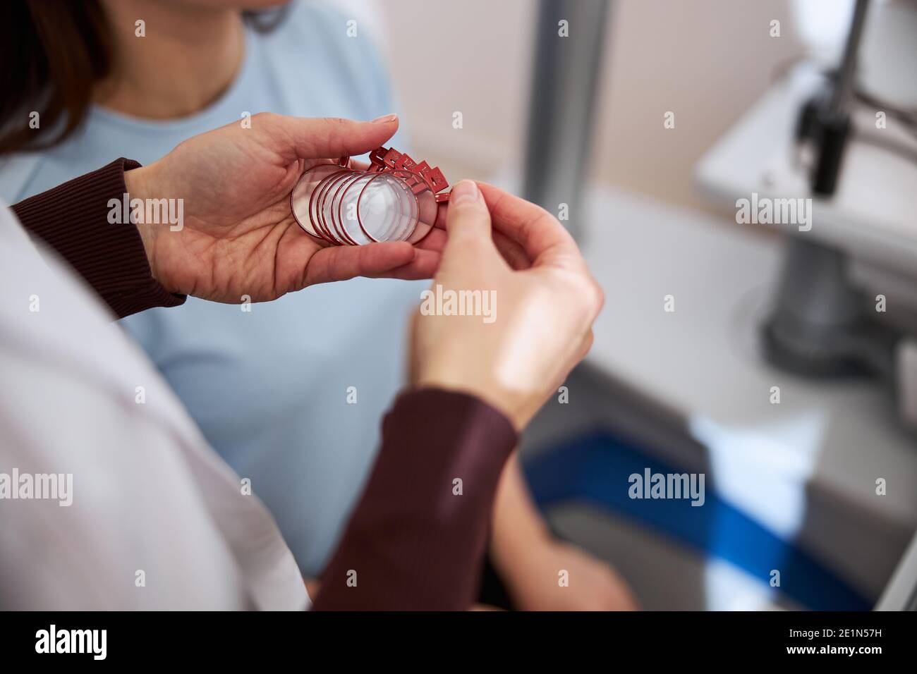 Ophthalmologist choosing the right lens for a check Stock Photo - Alamy