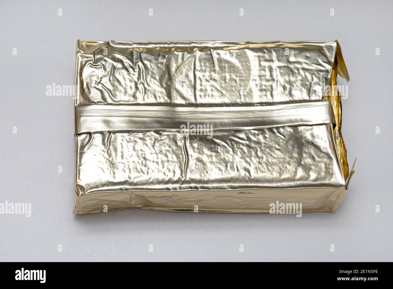 Ground Coffee Vacuum Packaging in Golden Foil Stock Photo - Alamy