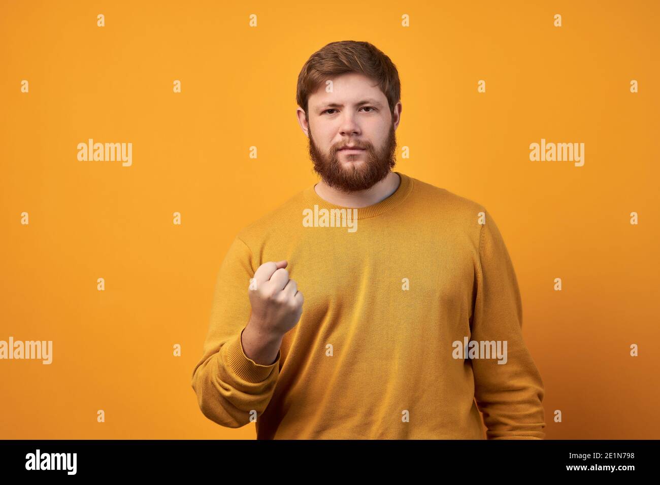 Angry strict man with thick beard, being furious, expresses warning and ...