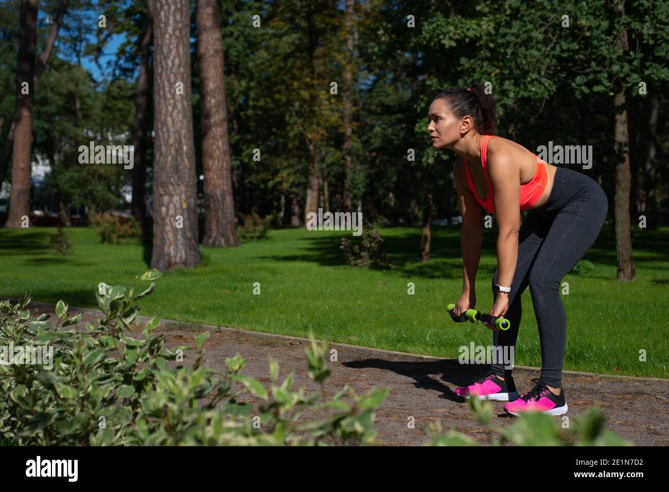 deadlift exercise outdoor in the city pine park. Woman doing deadlift ...