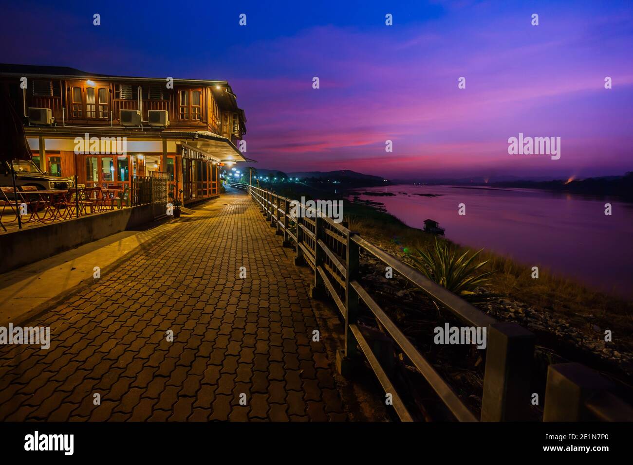 Wooden house beside river againts colorful sky Stock Photo - Alamy