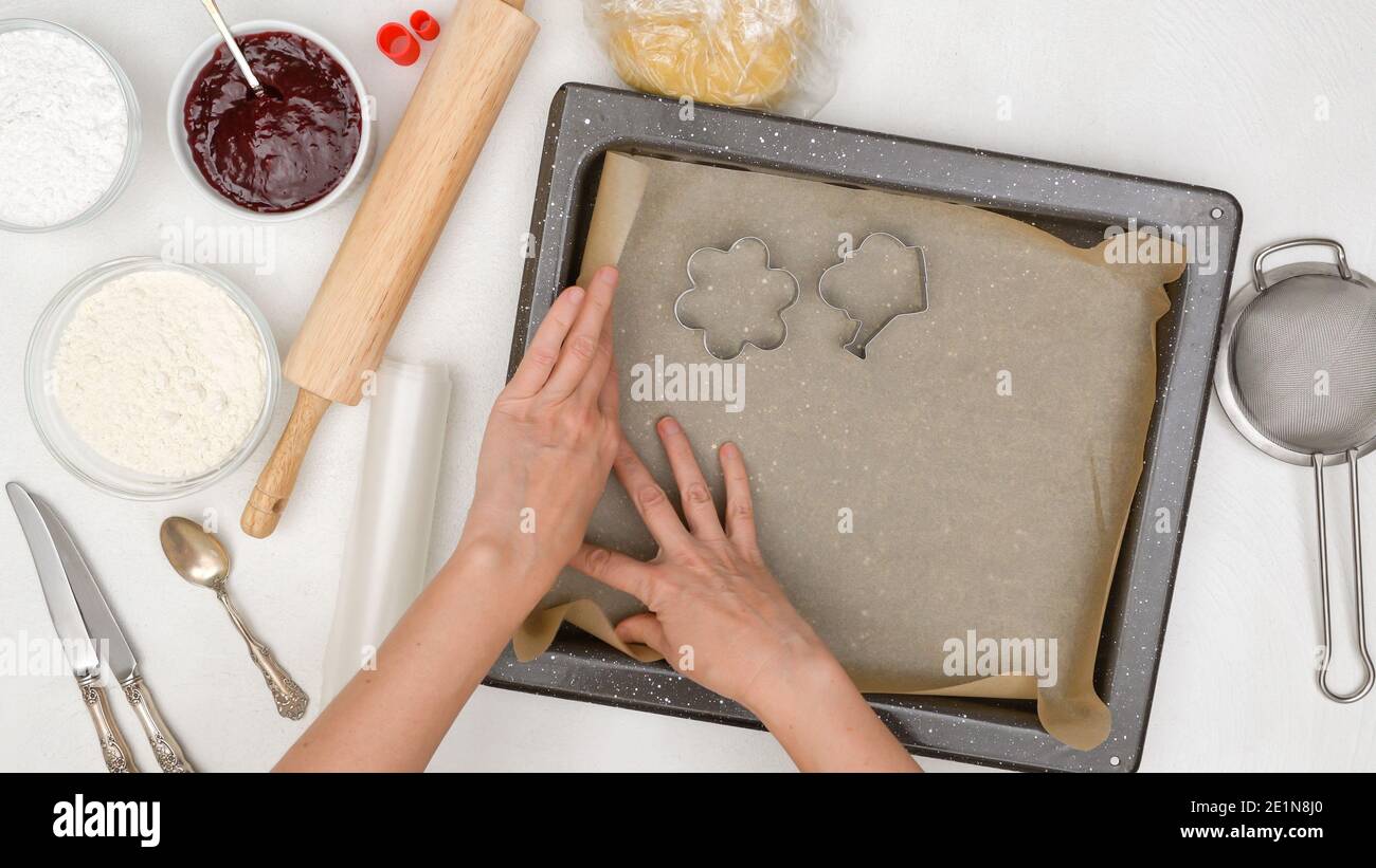 Woman hands line baking pan with parchment paper. Shortbread cookie ...