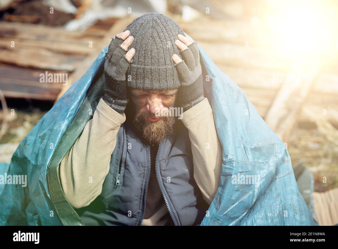 sad and upset homeless and unemployed person in ruins, economic ...