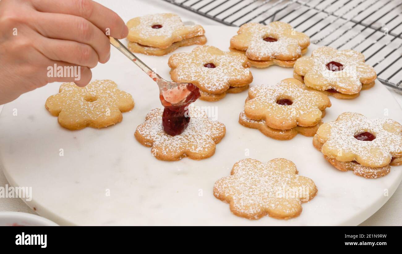 Flower shaped shortbread cookies filled with raspberry jam step by step ...