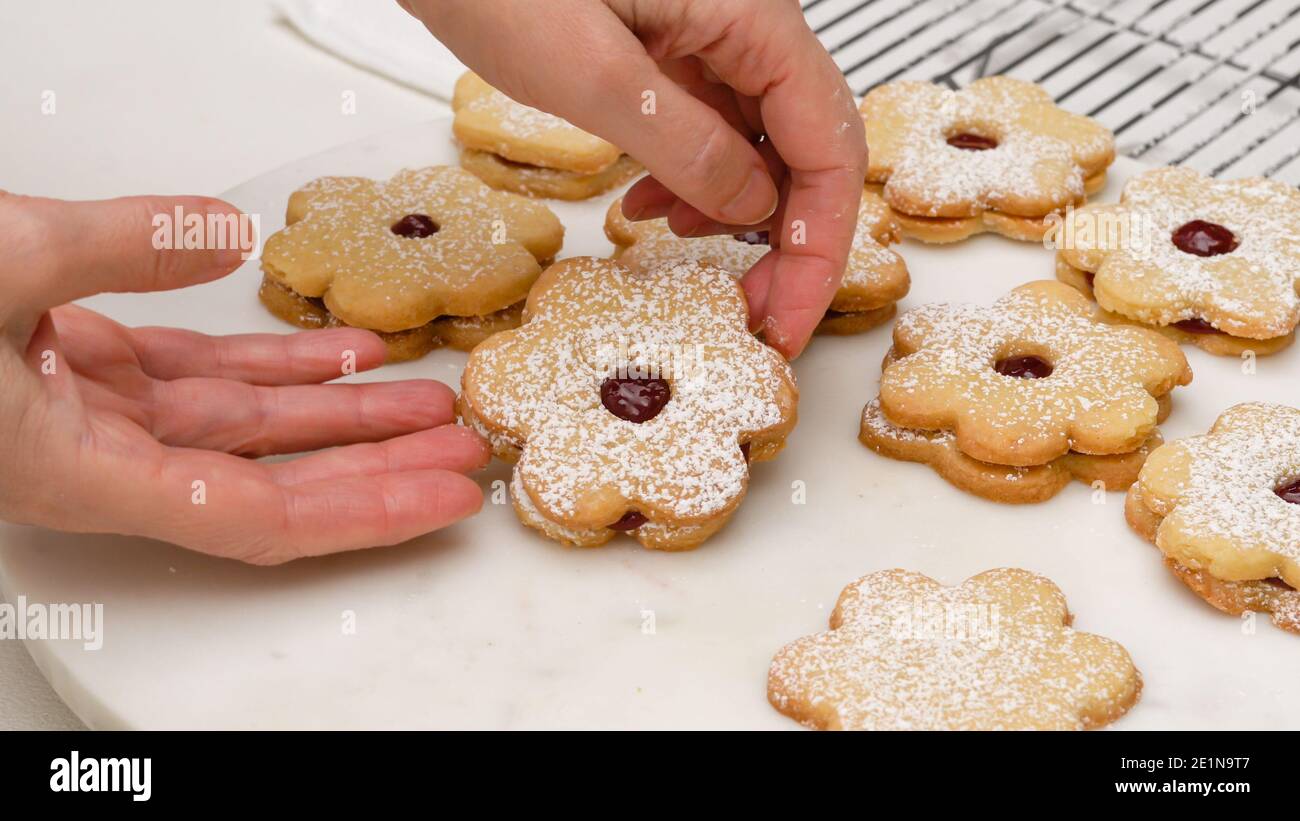 Flower shaped shortbread cookies filled with raspberry jam step by step ...