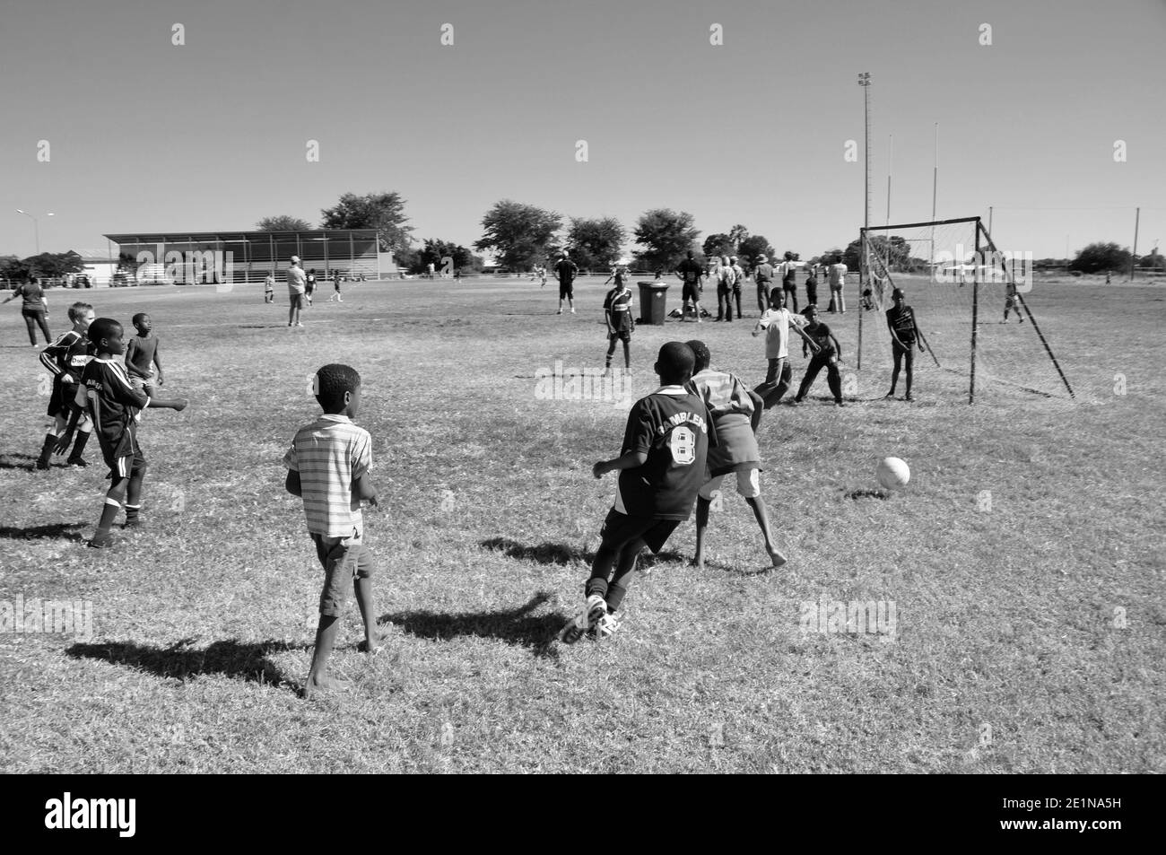 Children at school playing football Black and White Stock Photos ...