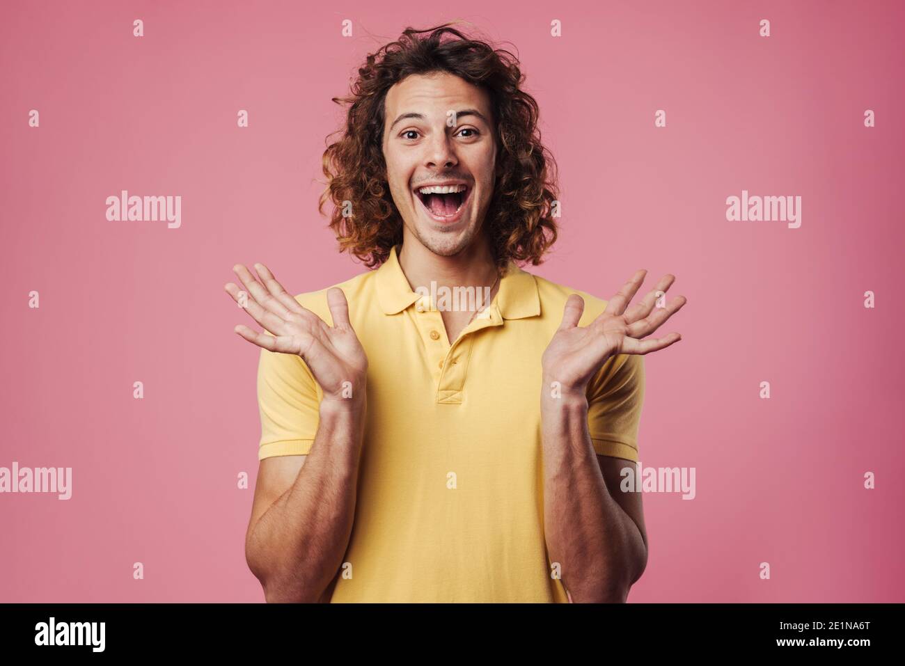 Excited handsome guy pointing expressing surprise on camera isolated ...