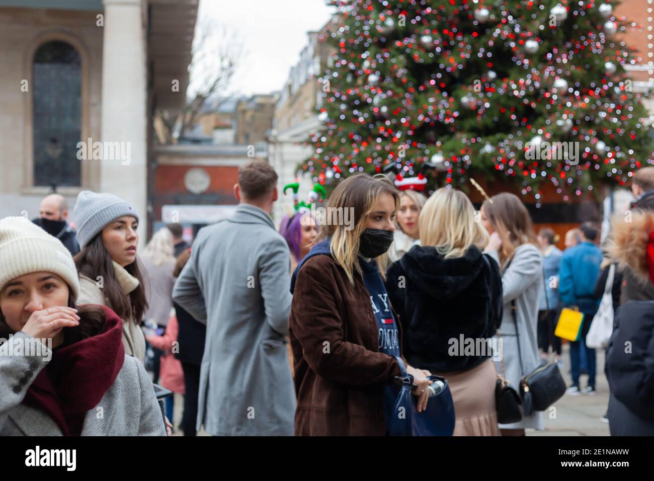 Britain in Pandemic - Upbeat crowd of Christmas revellers at Covent ...