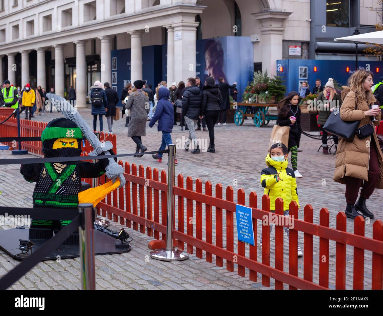 Street scene of Lego Ninja Warrior and young asian boy looking on ...