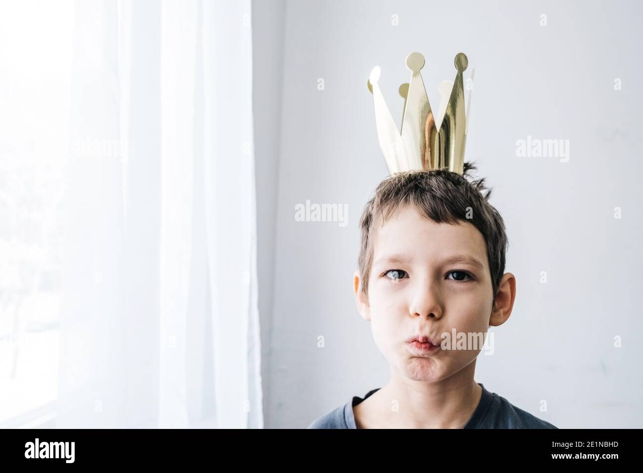 Portrait of cute autism child boy wearing a toy crown. Autism awareness ...
