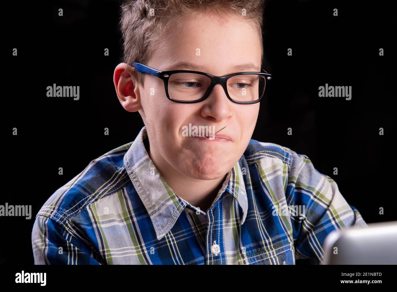 Boy with toothpick glasses at home learning Stock Photo - Alamy