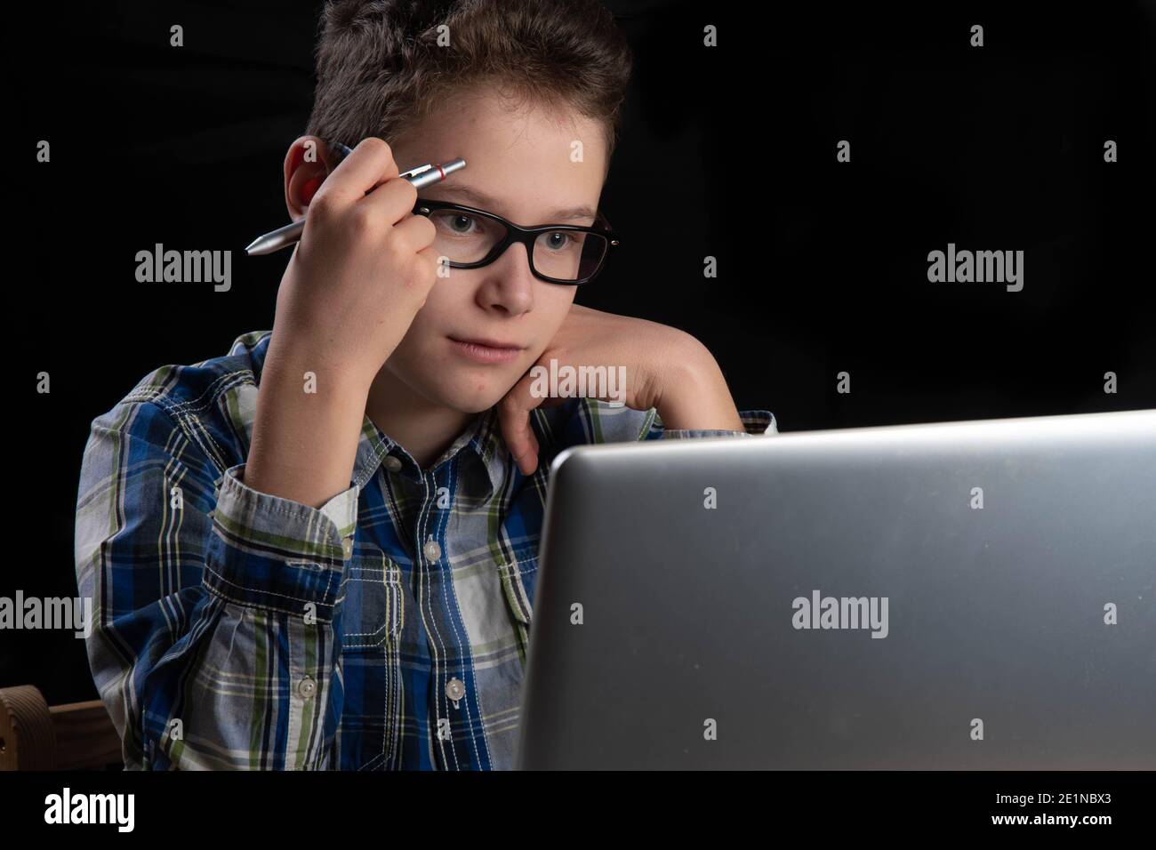 Student on laptop at home with pen Stock Photo - Alamy