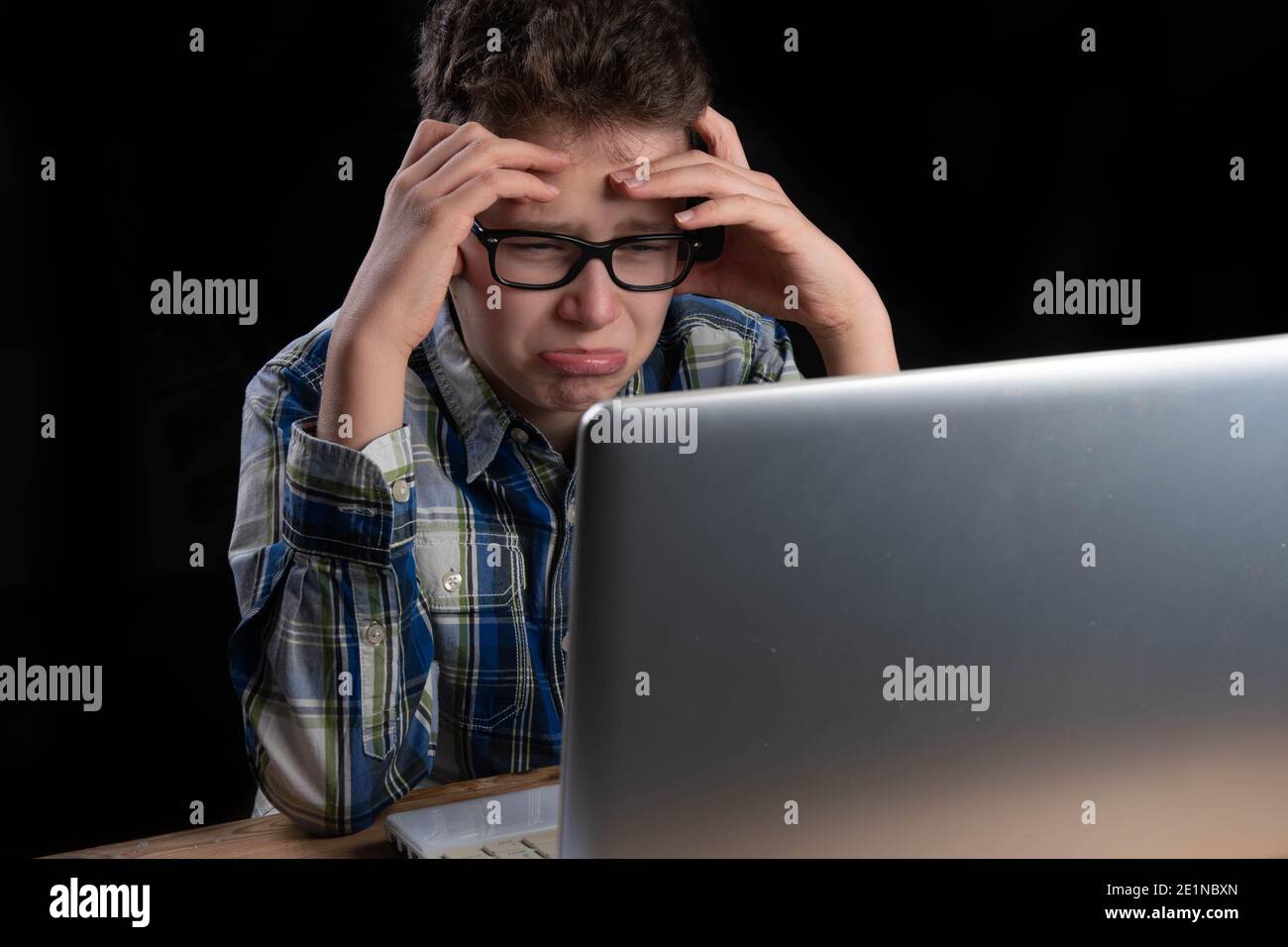 Pupil crying at computer homeschooling Stock Photo - Alamy
