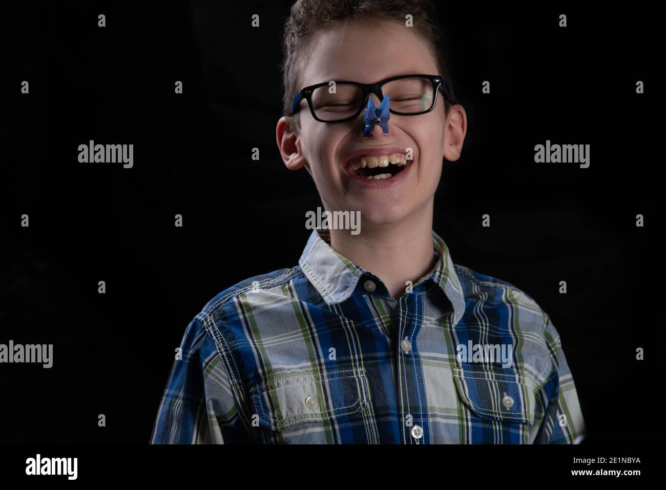 Boy funny with clothespin on nose Stock Photo - Alamy