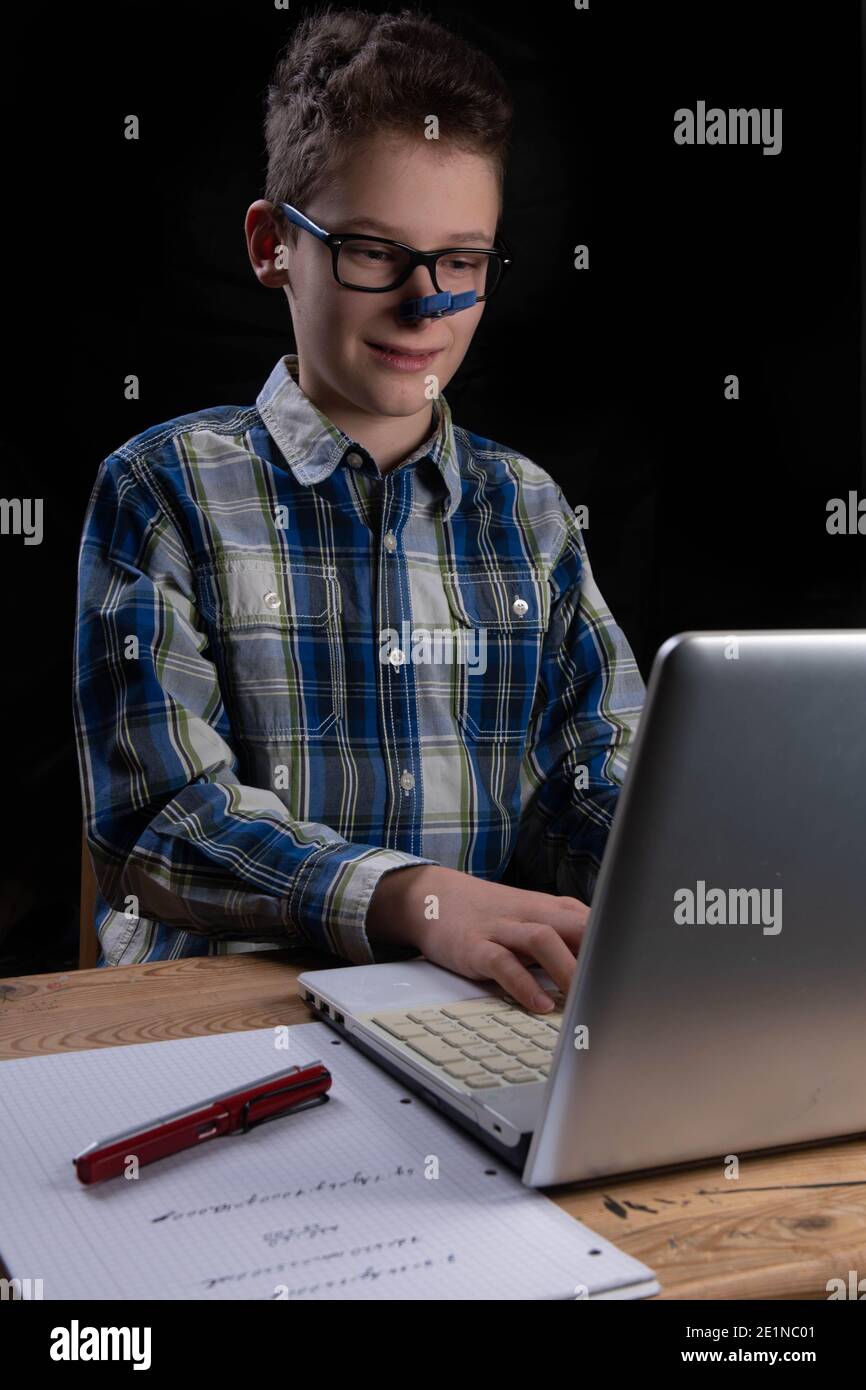 Boy typing on computer at home for school Stock Photo - Alamy