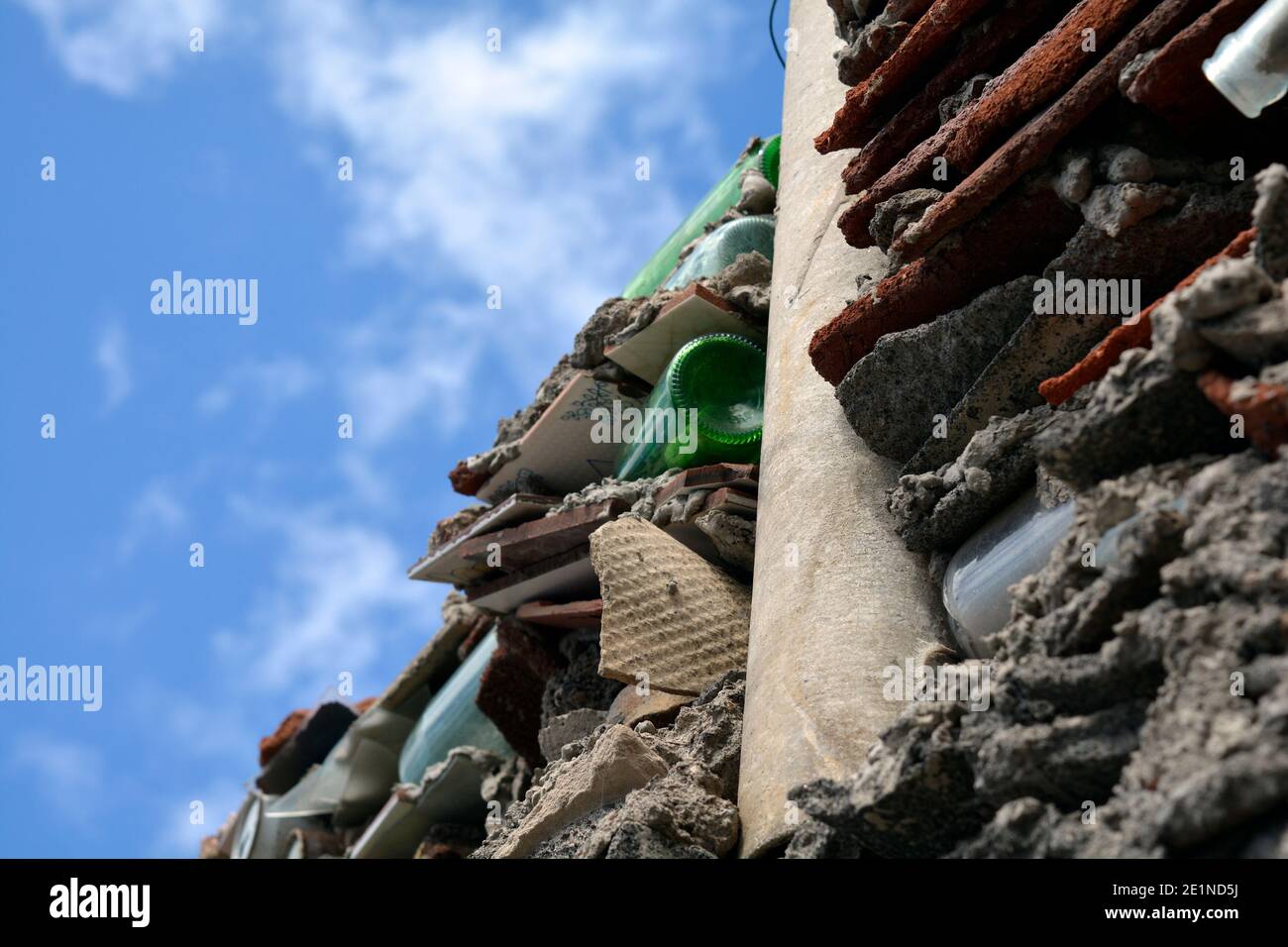 A wall that has been repaired using salvaged scrap materials Stock ...
