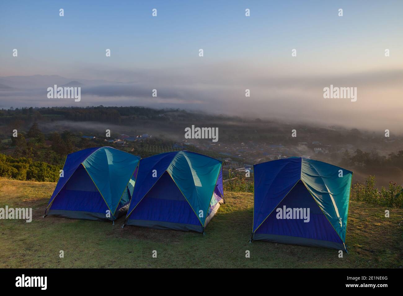 Camping tent on green grass field on mountain Stock Photo - Alamy