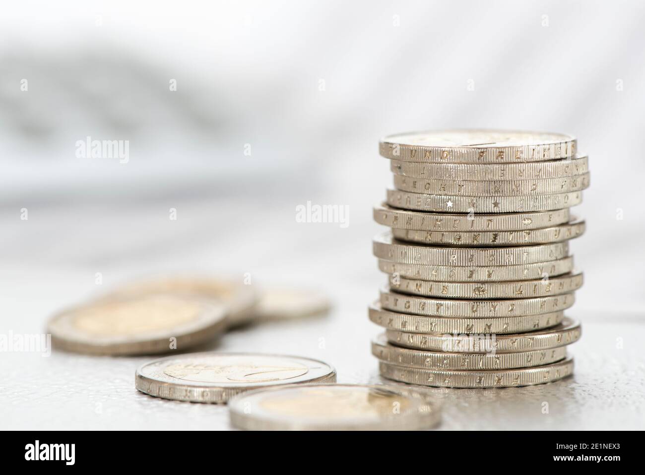 stack of Euro coins in financial data and chart Stock Photo - Alamy