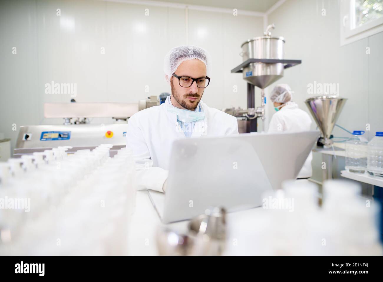 Hard working lab employee working on a computer Stock Photo - Alamy