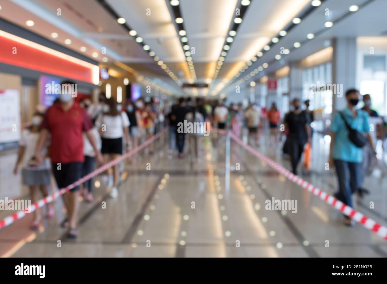 People wear face mask walk in building Stock Photo - Alamy