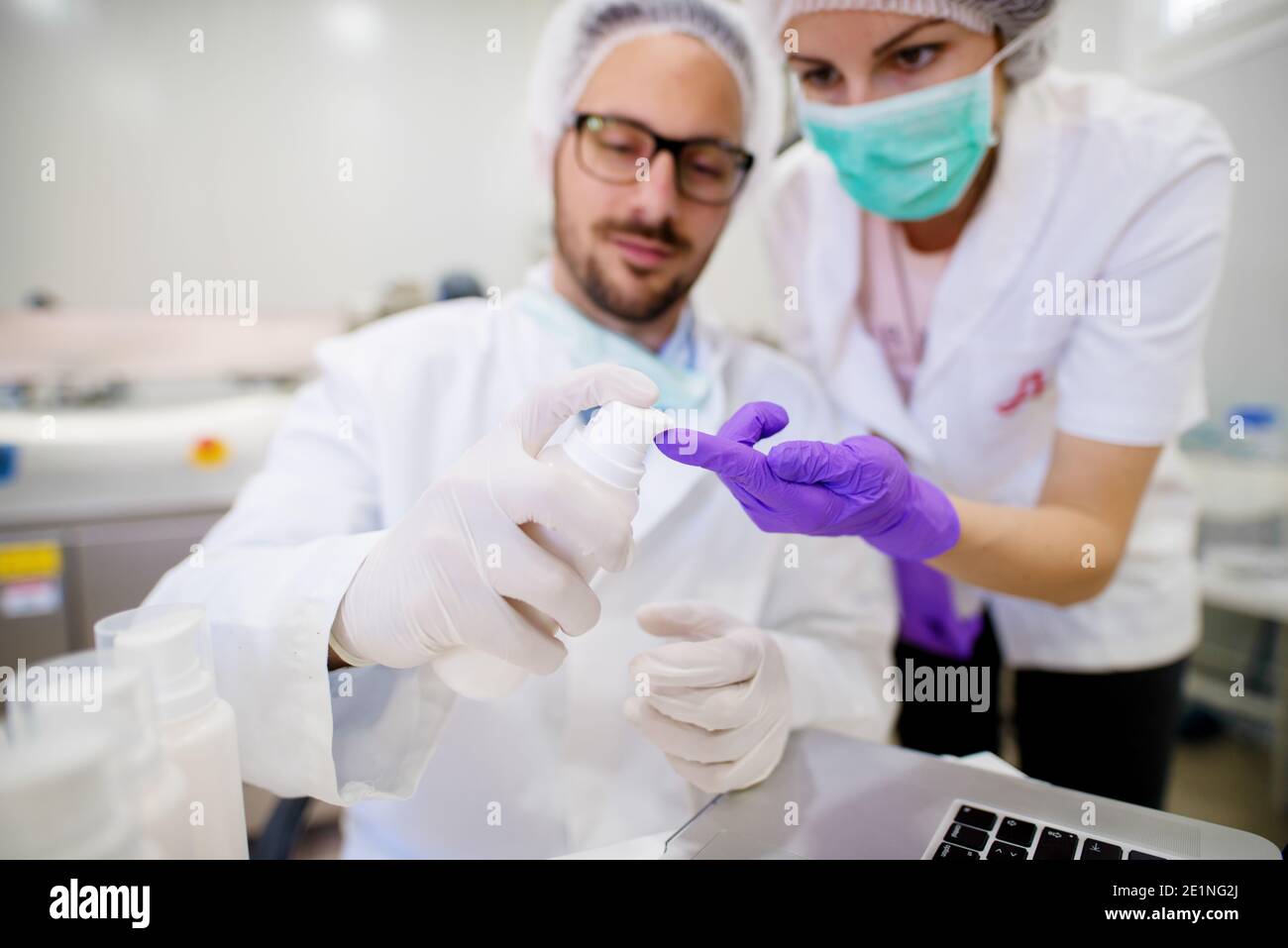 Two lab employees with protective wear testing new products Stock Photo ...
