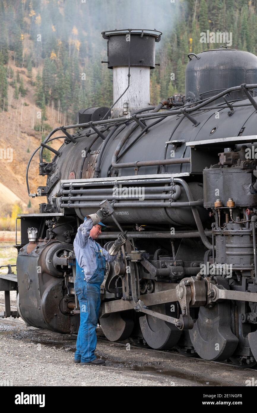 The train engineer maintaining the Rio Grande class steam locomotive ...
