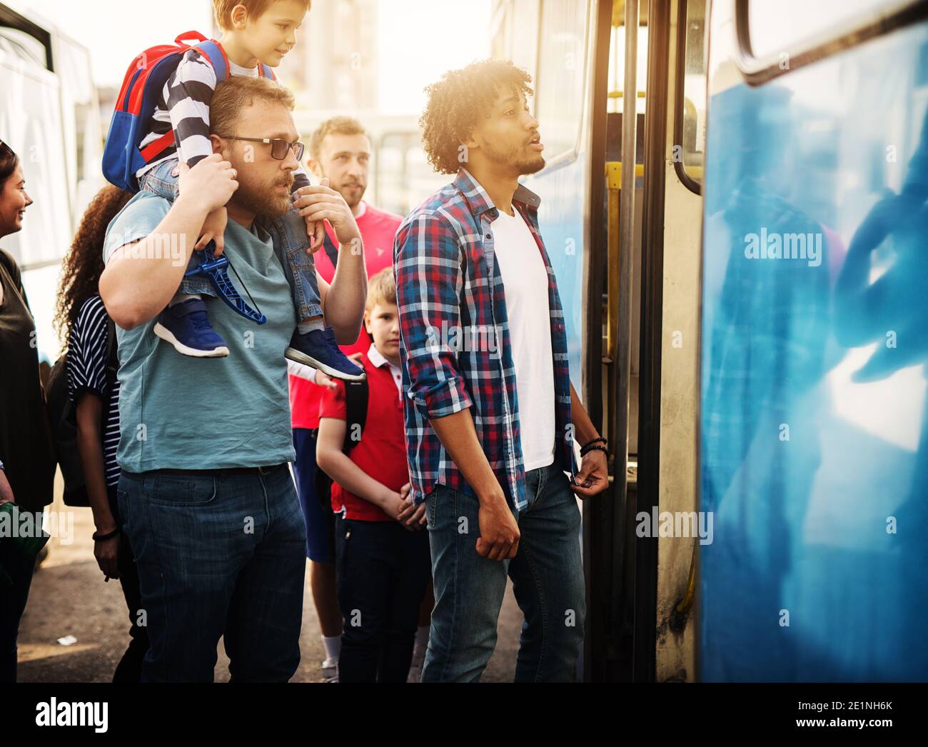 Group of people is waiting in line to get in to a bus Stock Photo - Alamy