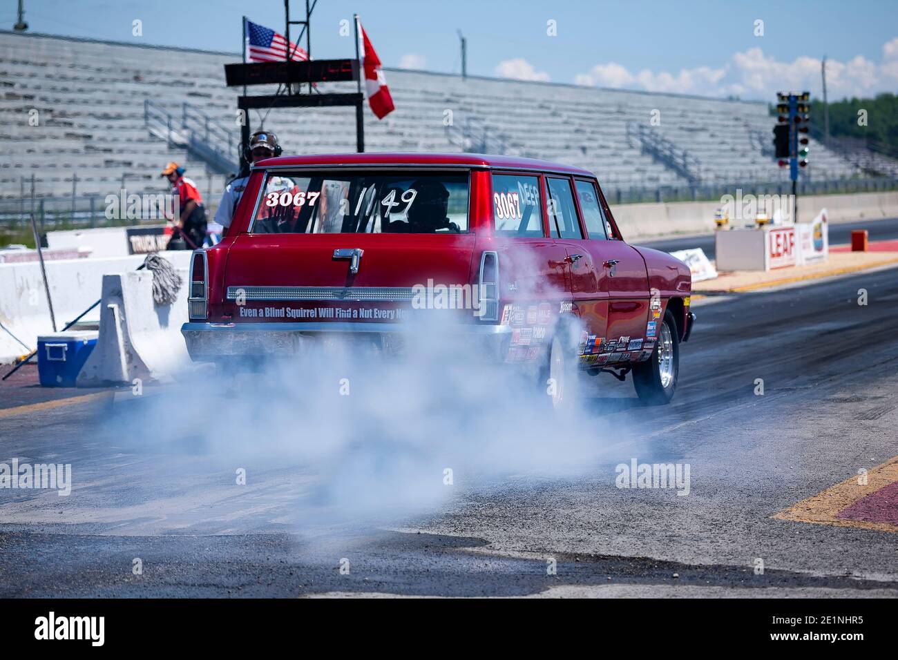 Chevy II Station Wagon performing a burnout at drag strip Stock Photo ...