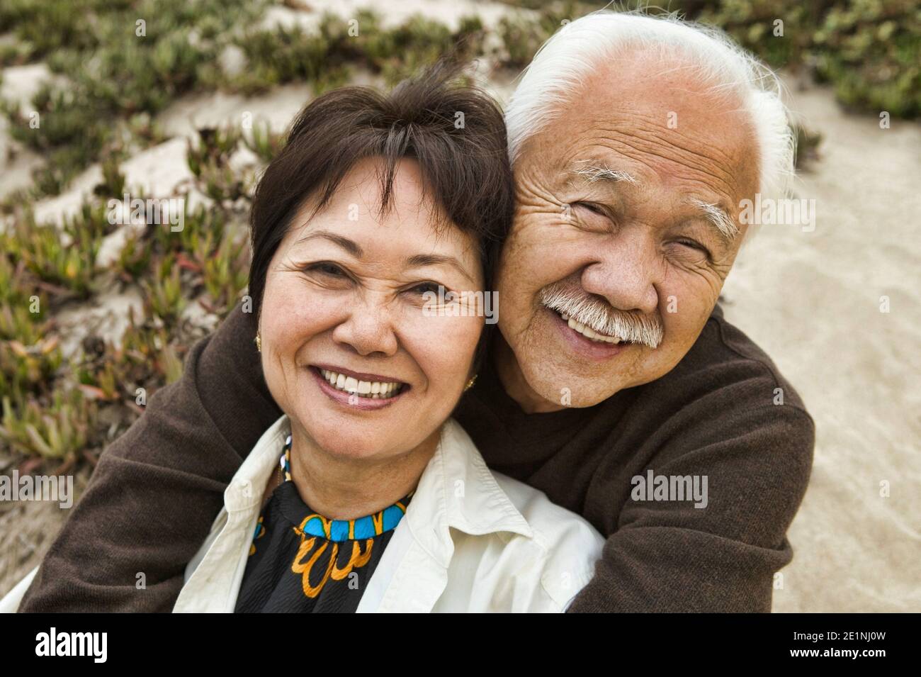 Happy Mature Couple Hugging on Beach Stock Photo - Alamy