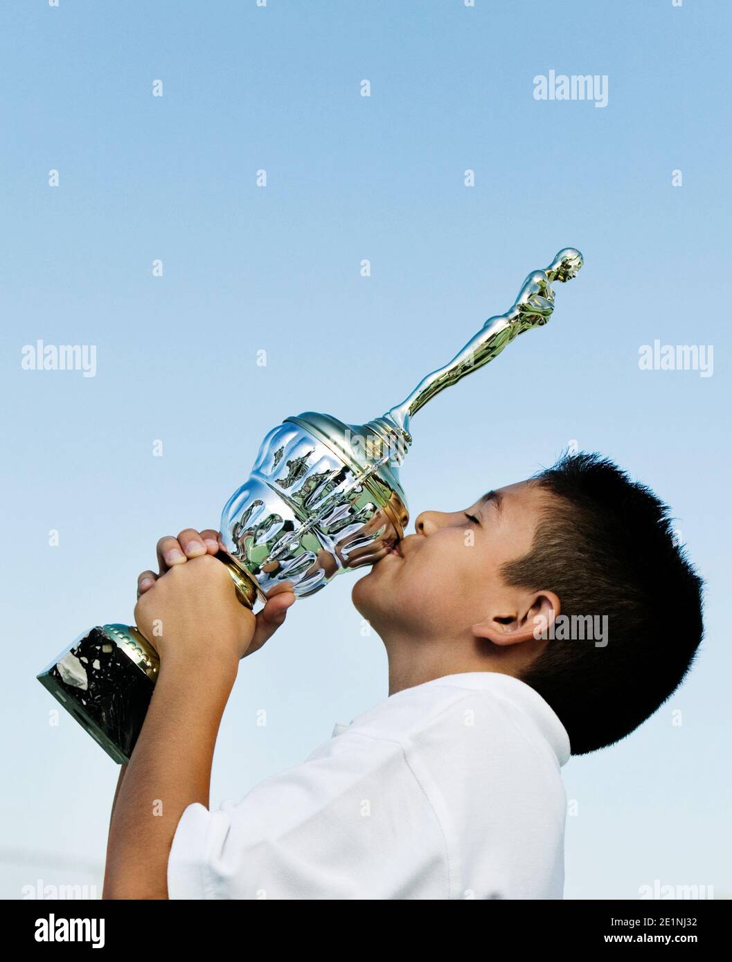 Photo of Kid Tennis Player Kissing Trophy Stock Photo - Alamy