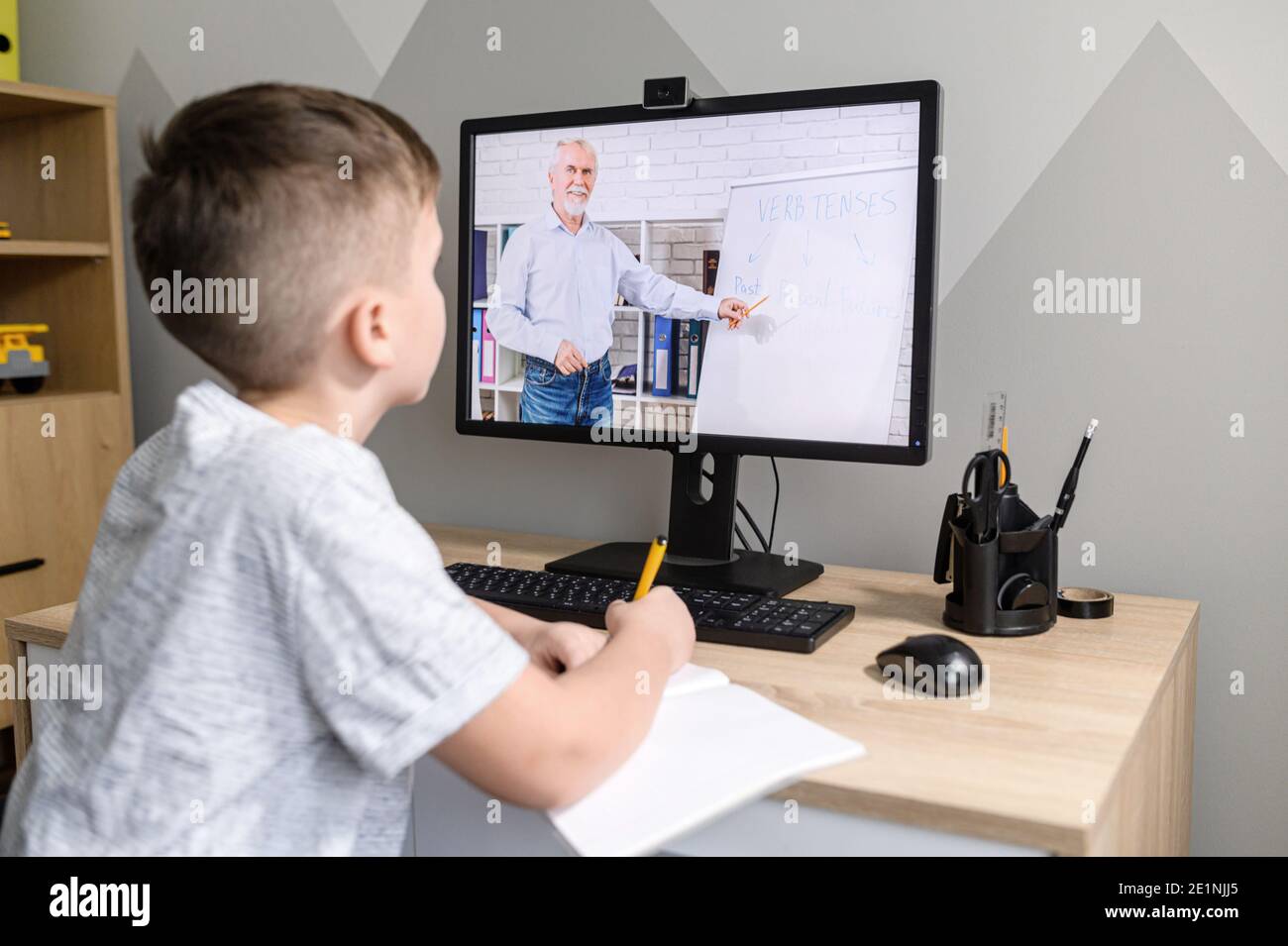Schoolkid watching online video classes on the PC Stock Photo - Alamy
