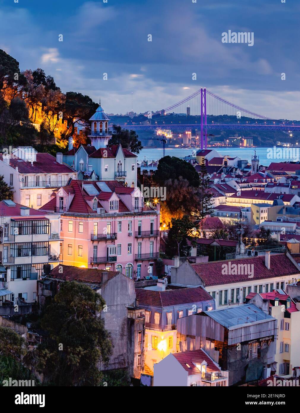Cityscape of Lisbon at dusk with traditional historical houses and The ...