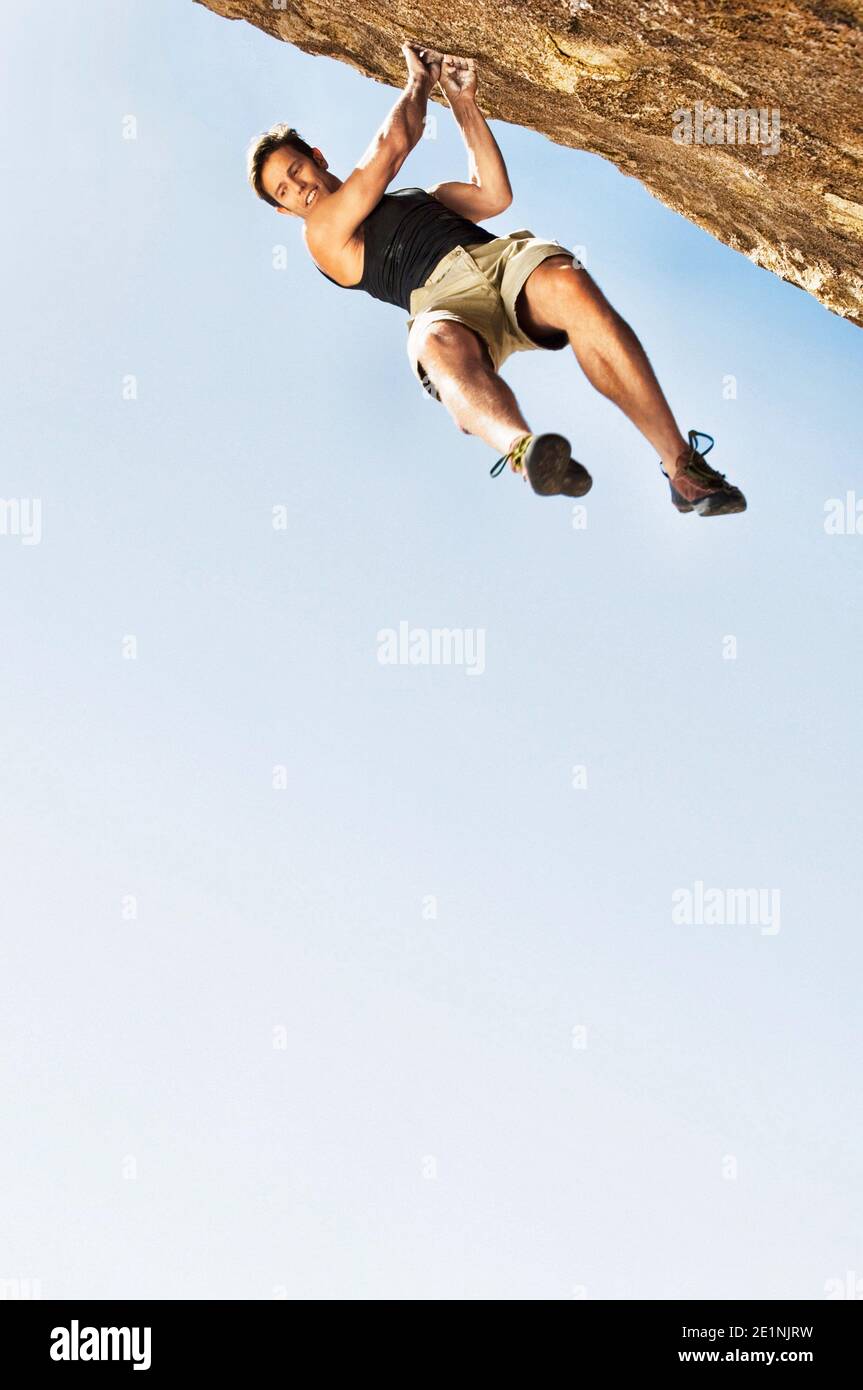 Photo of Climber Jumping off Cliff Stock Photo - Alamy