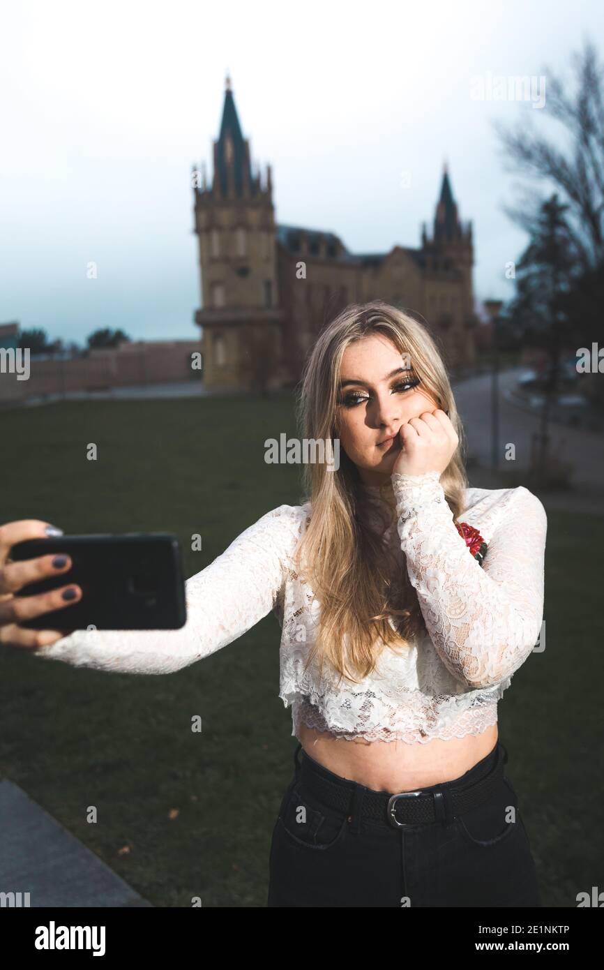 Young woman recording herself with a cell phone at the street Stock ...