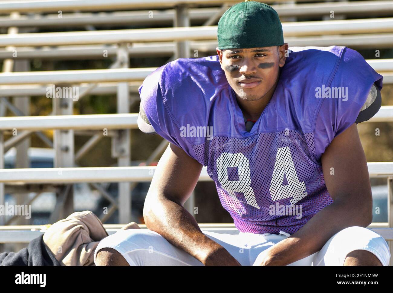Photo of Football Player Watching from Bleachers Stock Photo - Alamy