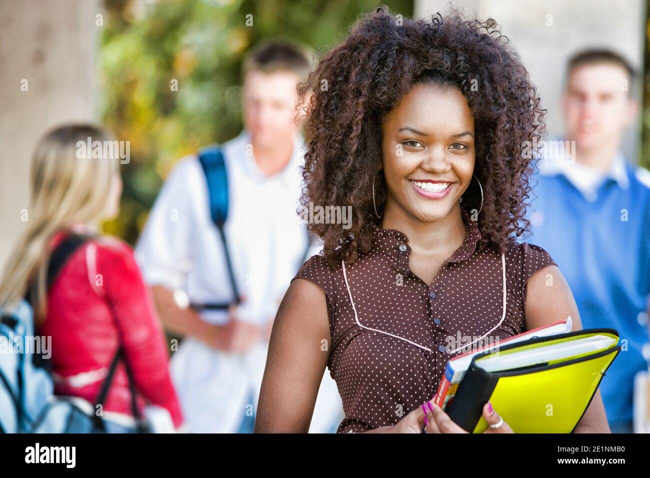 Portrait of smiling African American female student on college campus ...