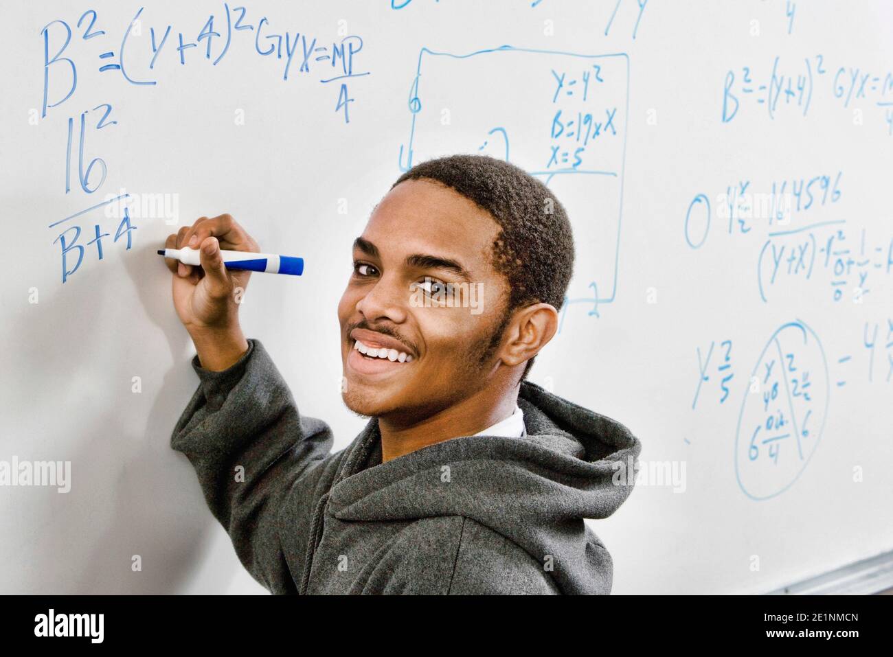 Portrait of smart african american student solving mathematics on white ...
