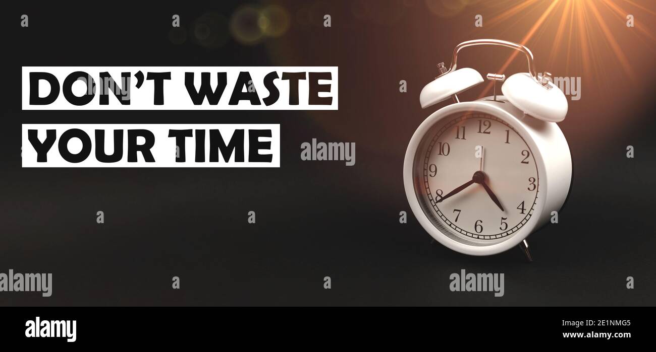 Don't waste time concept text with vintage alarm clock on black ...