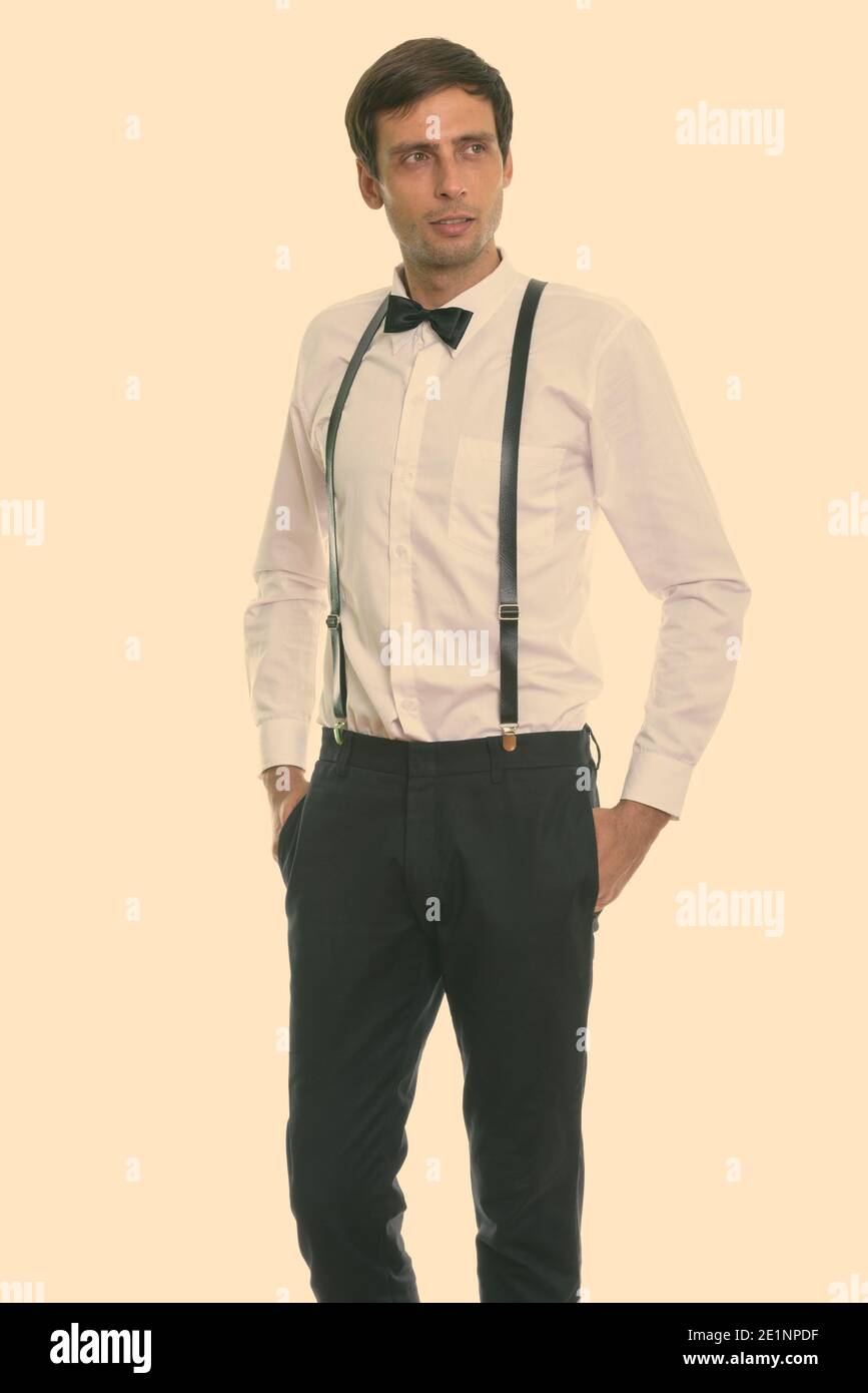 Studio shot of young handsome man standing and thinking while wearing ...